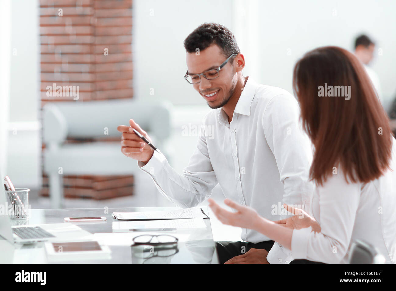 business people discuss something sitting at the office table . photo ...