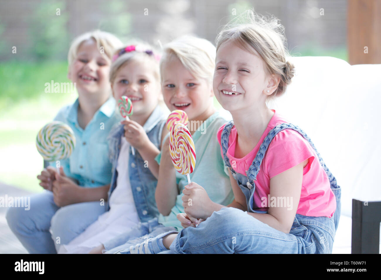 Group of happy smiling children with lollipops outdoors Stock Photo - Alamy