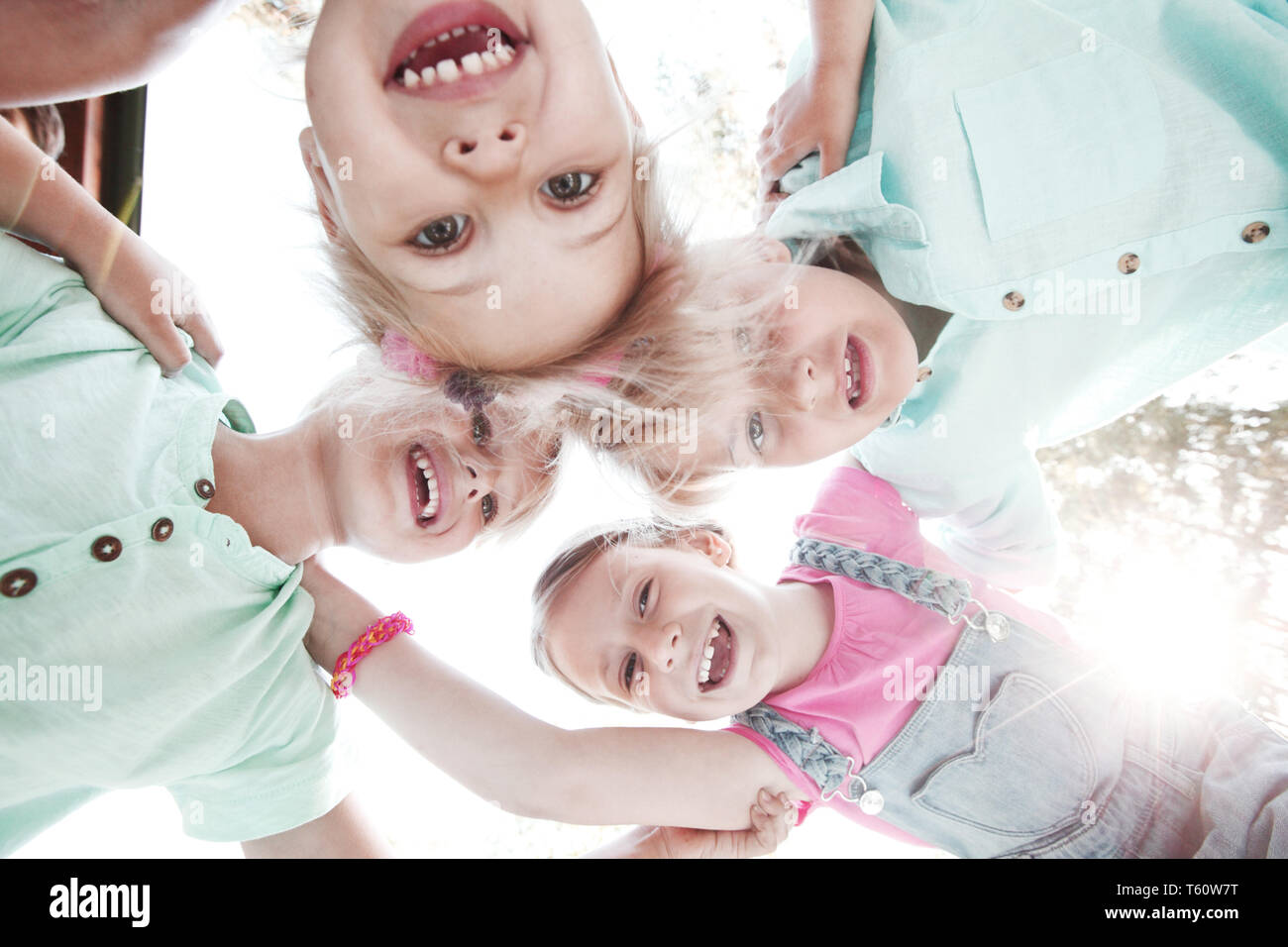 Group of smiling children looking down into camera Stock Photo - Alamy