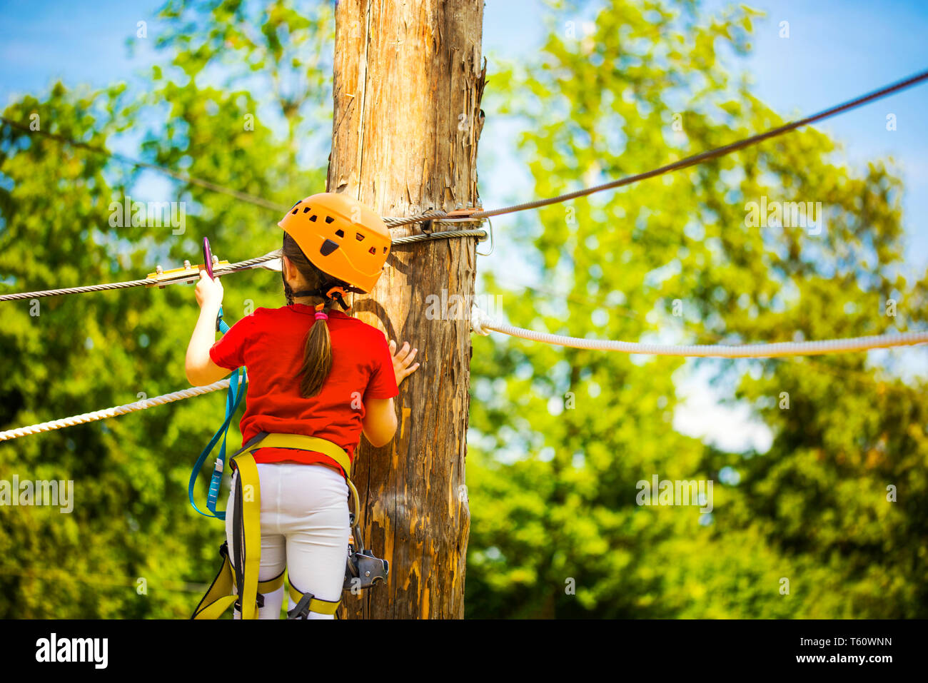 Little brave caucasian girl treerunner fasten the rollclip before ...