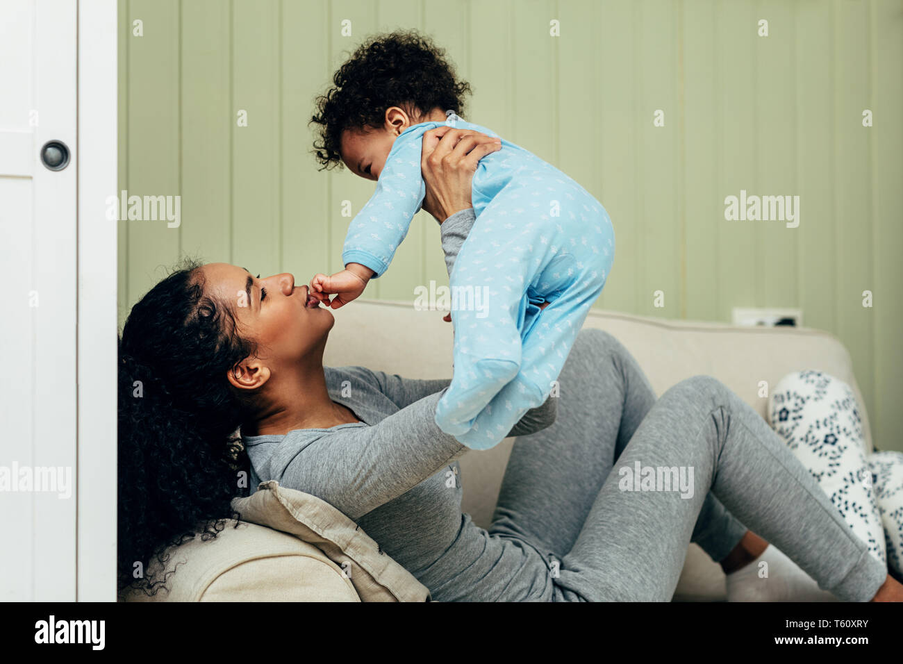 Lifting baby hi-res stock photography and images - Alamy