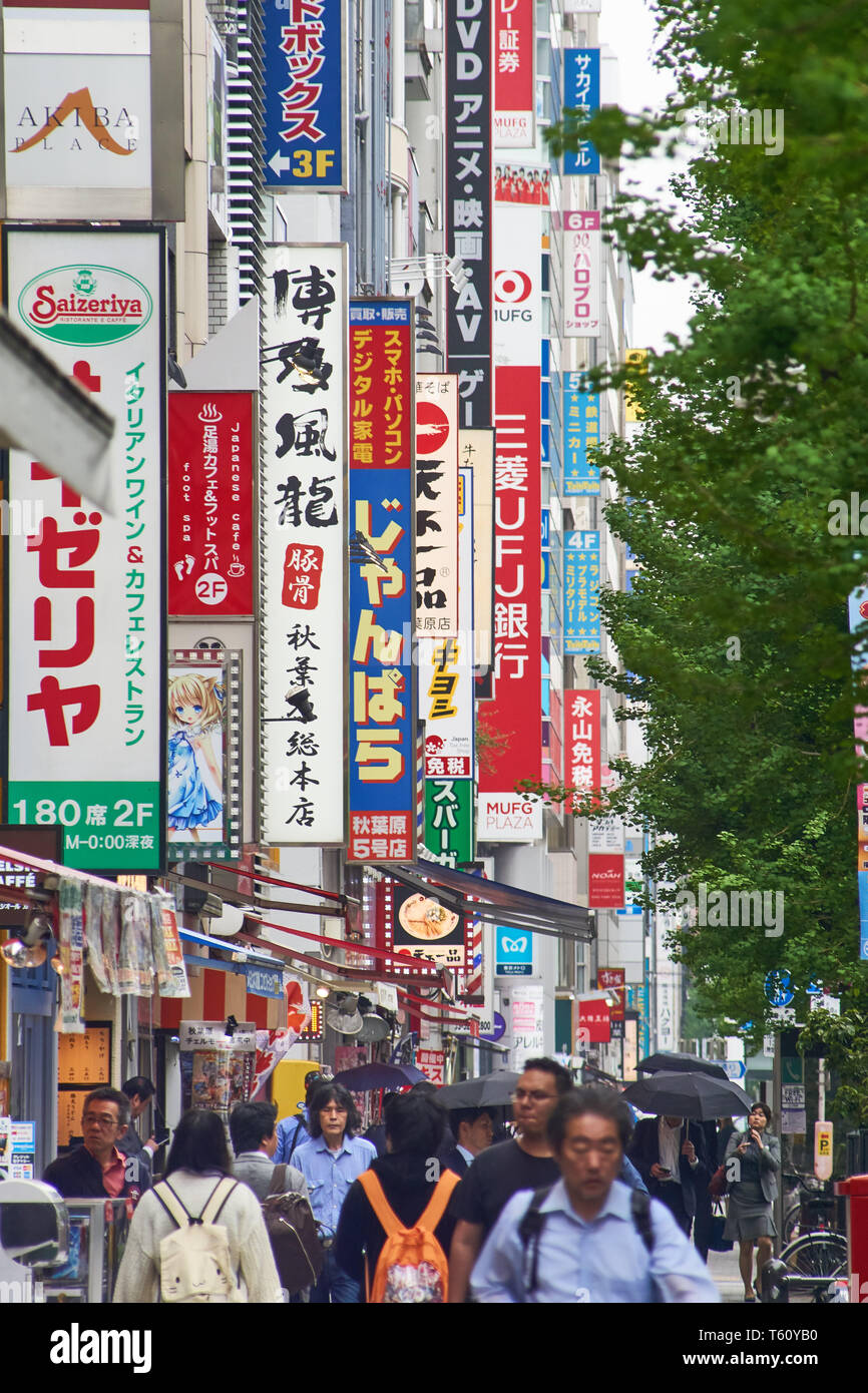 Towers, vertical signs, in Akihabara with the roads crowded with ...