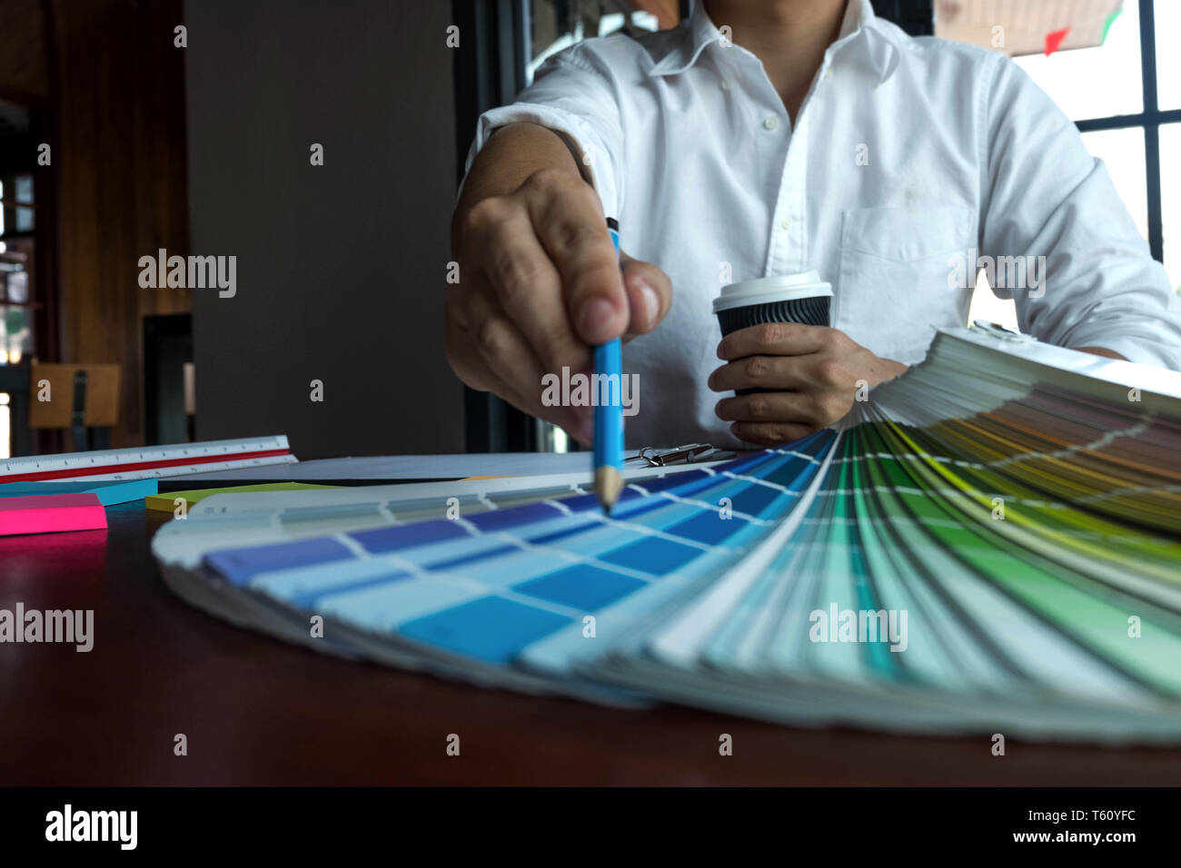 Graphic designer choose colors from the color bands samples for design ...