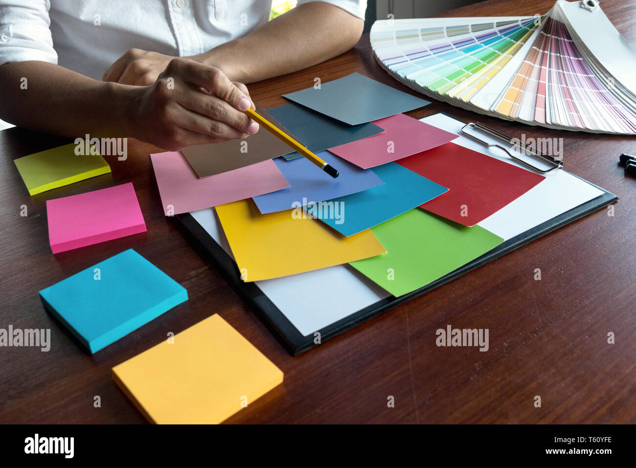 Graphic designer choose colors from the color bands samples for design ...