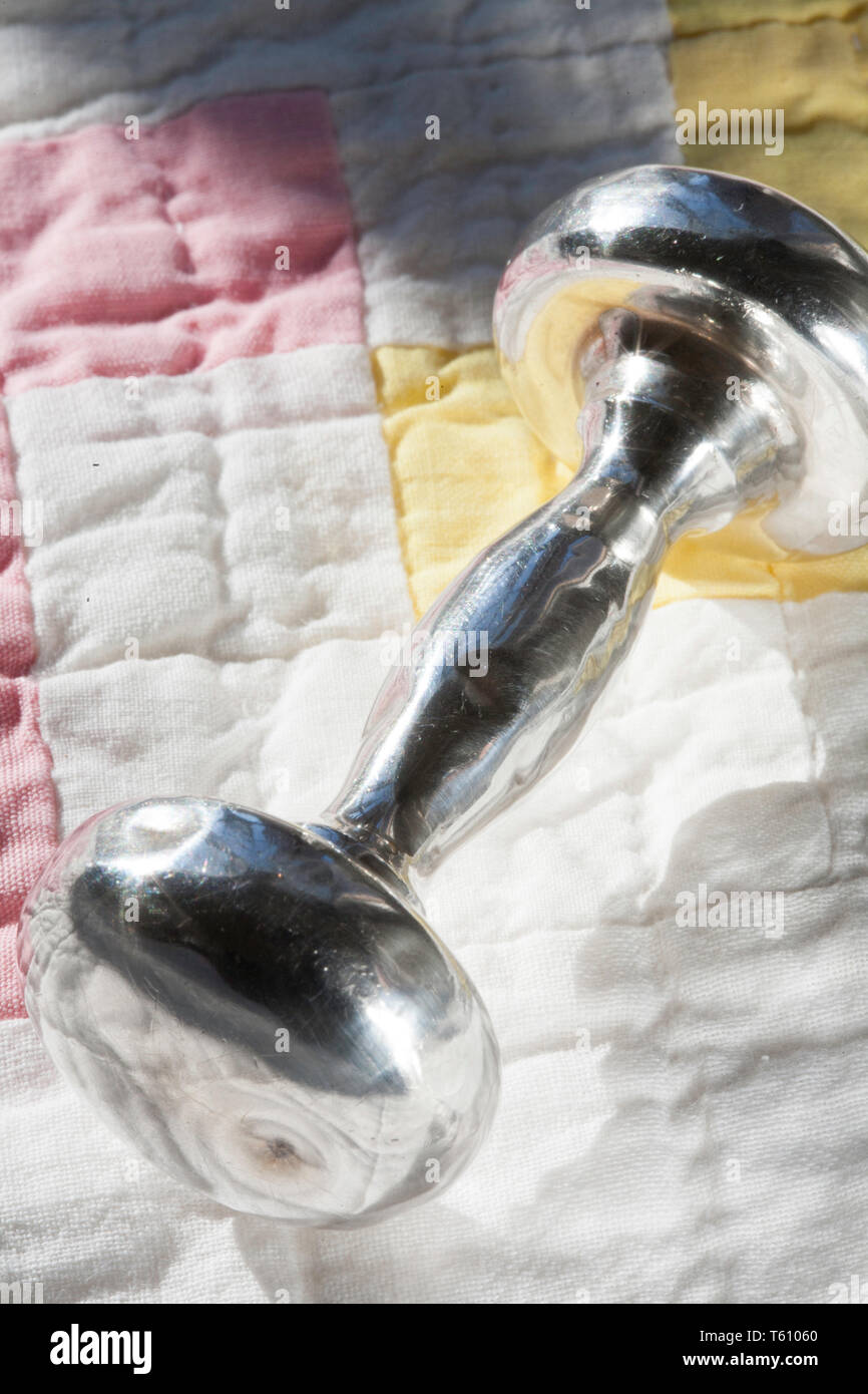 Vintage silver rattle on a baby's quilt close up, USA Stock Photo - Alamy