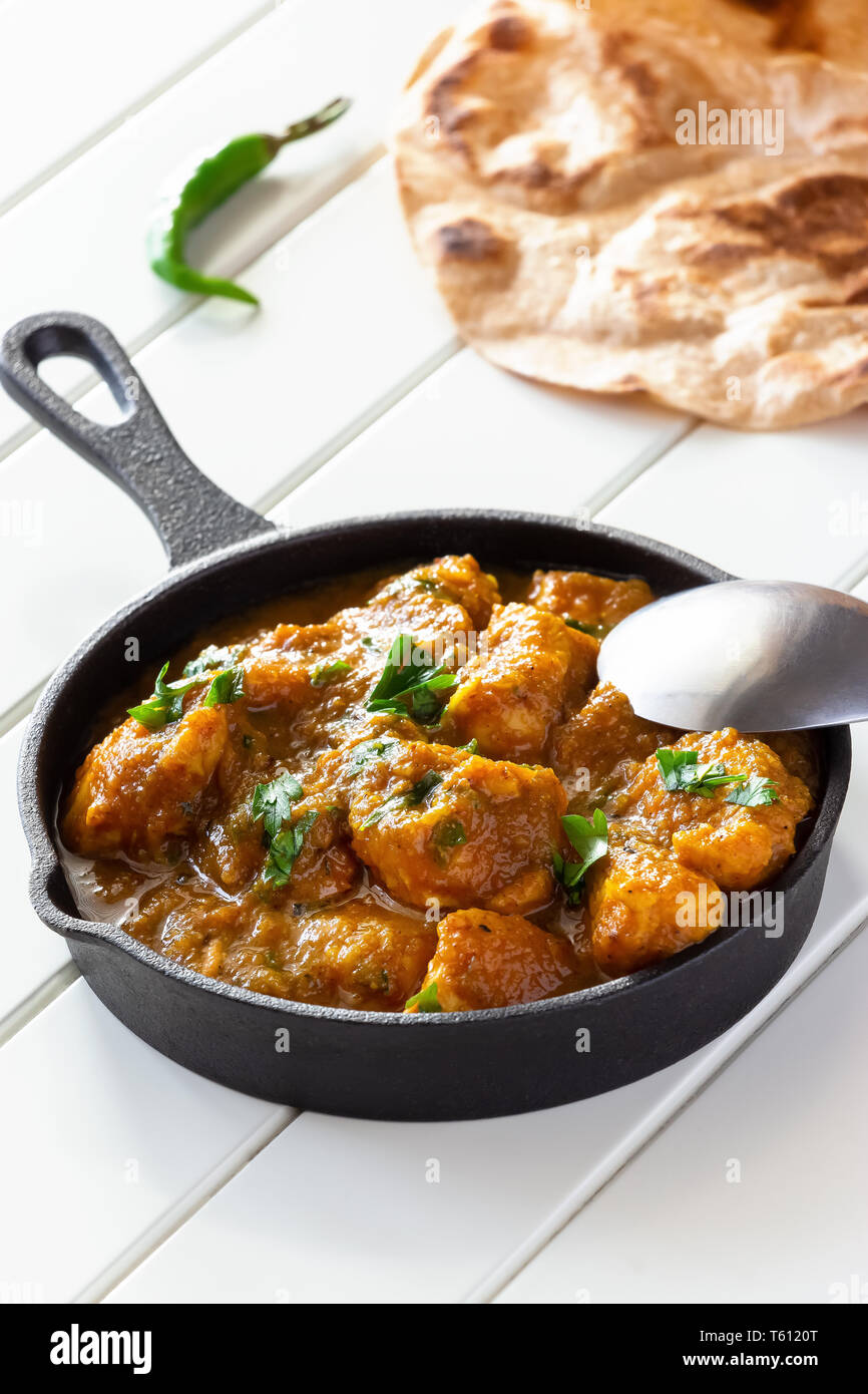 Closeup traditional Indian butter chicken curry and lemon served with ...