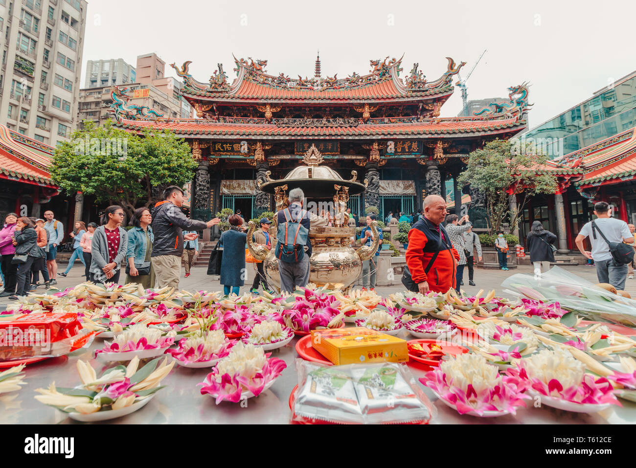 Foods and Flowers placed by visitors at Longshan Temple, one of the ...