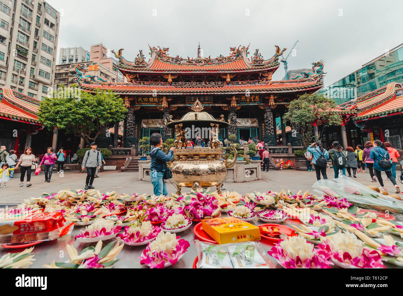 Foods and Flowers placed by visitors at Longshan Temple, one of the ...