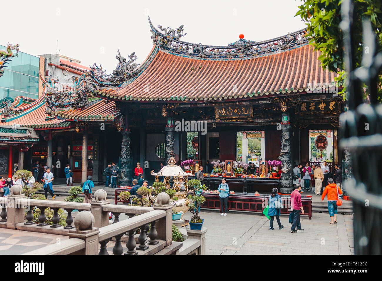 Main entrance gate at Longshan Temple with tourist and local people ...