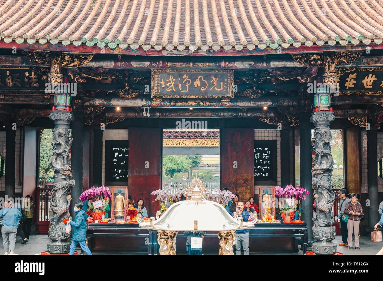 Main entrance gate at Longshan Temple with tourist and local people ...