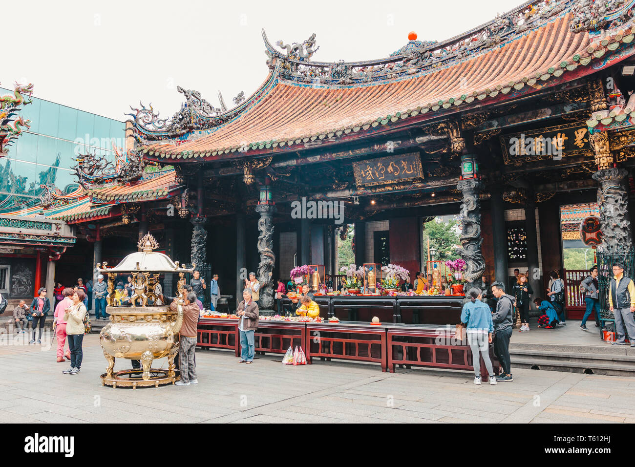 Main entrance gate at Longshan Temple with tourist and local people ...