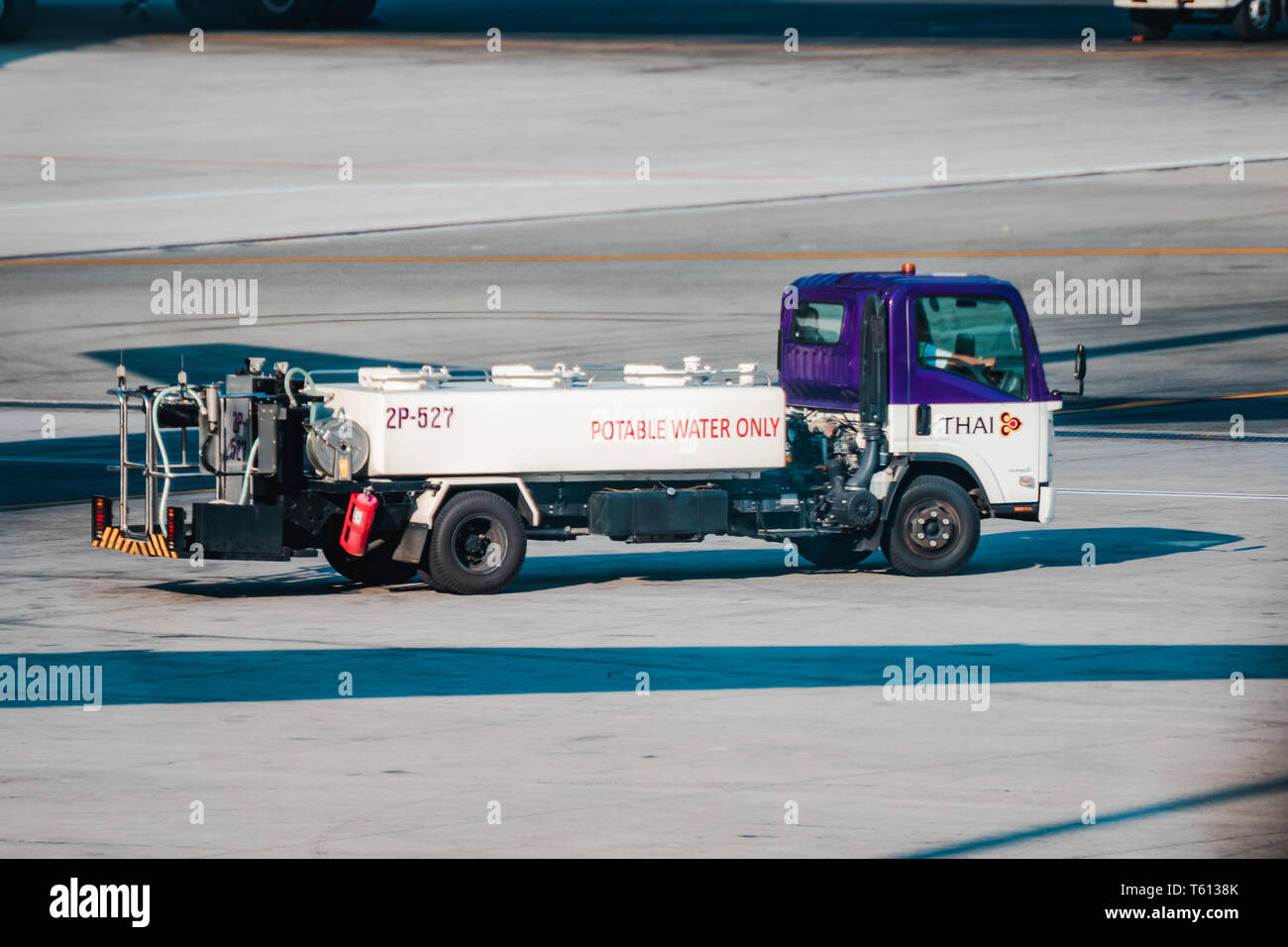 Thai airways Drinking water truck driving to an airplane to refill its ...