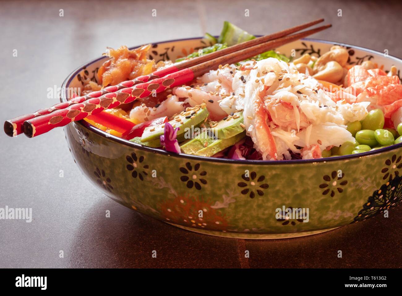 Poke bowl made with fresh seafood, vegetables, fruits and nuts Stock ...
