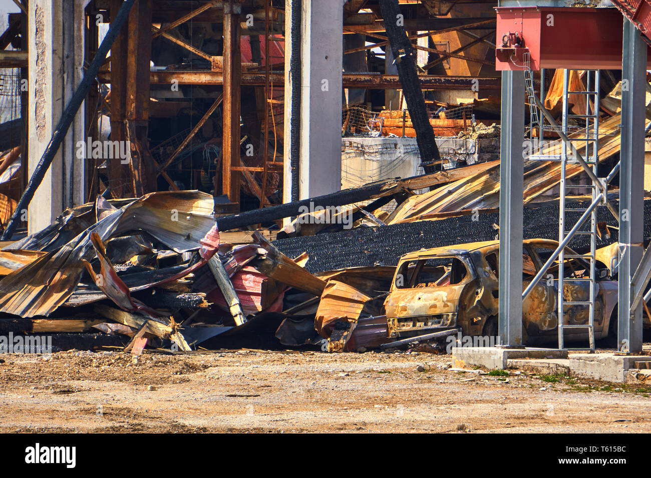 Machines and Burned Building Remains of a Sawmill Fire Stock Photo - Alamy