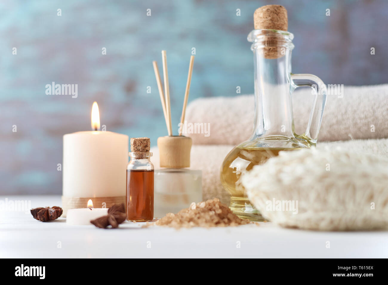 Spa and relax composition with massage oil, towels and burning candle ...