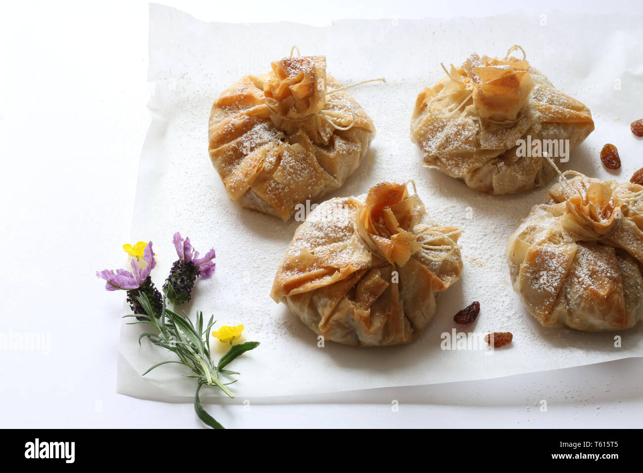 Phyllo pastry strudel with apple filling and sultana grapes, dusted ...