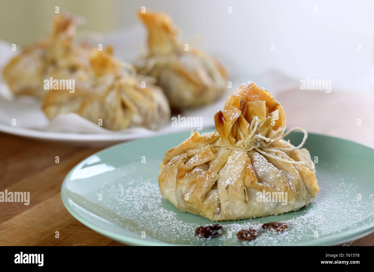 Phyllo pastry strudel with apple filling and sultana grapes, dusted ...