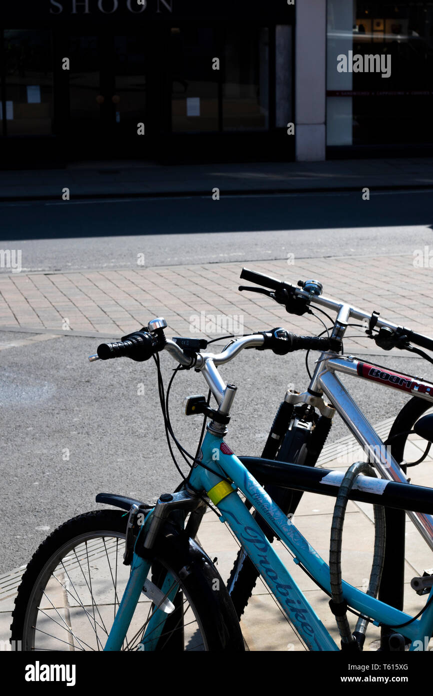 bicycles chained to bike parking rack located in City centre shopping ...