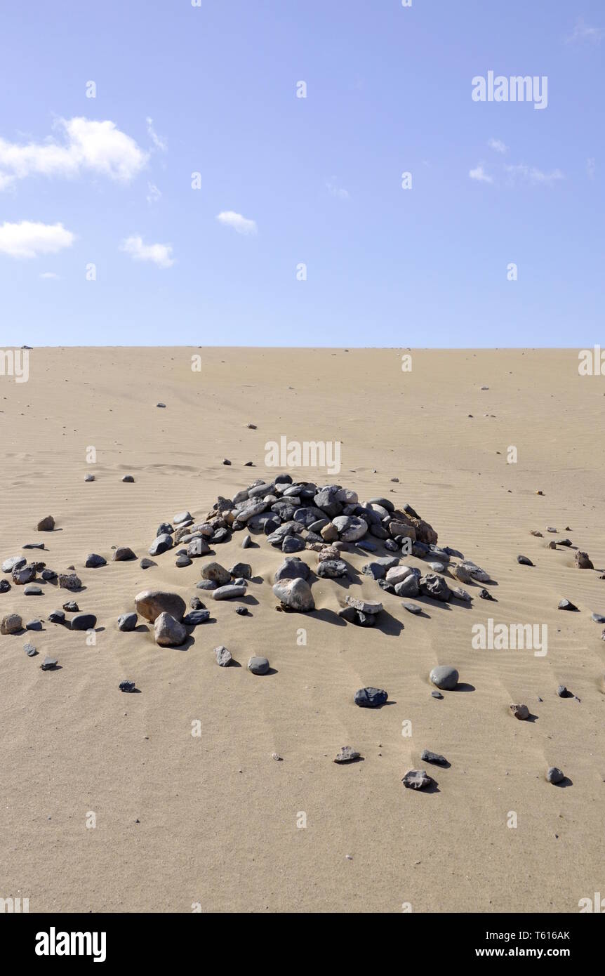 Pile of stones in a desert in Maspalomas, Spain Stock Photo - Alamy
