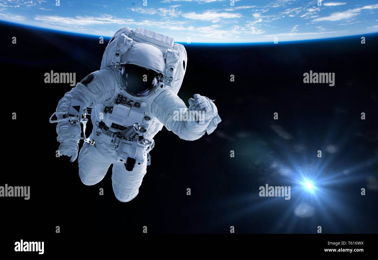astronaut in orbit of the planet Earth lit by the Sun (3d render ...