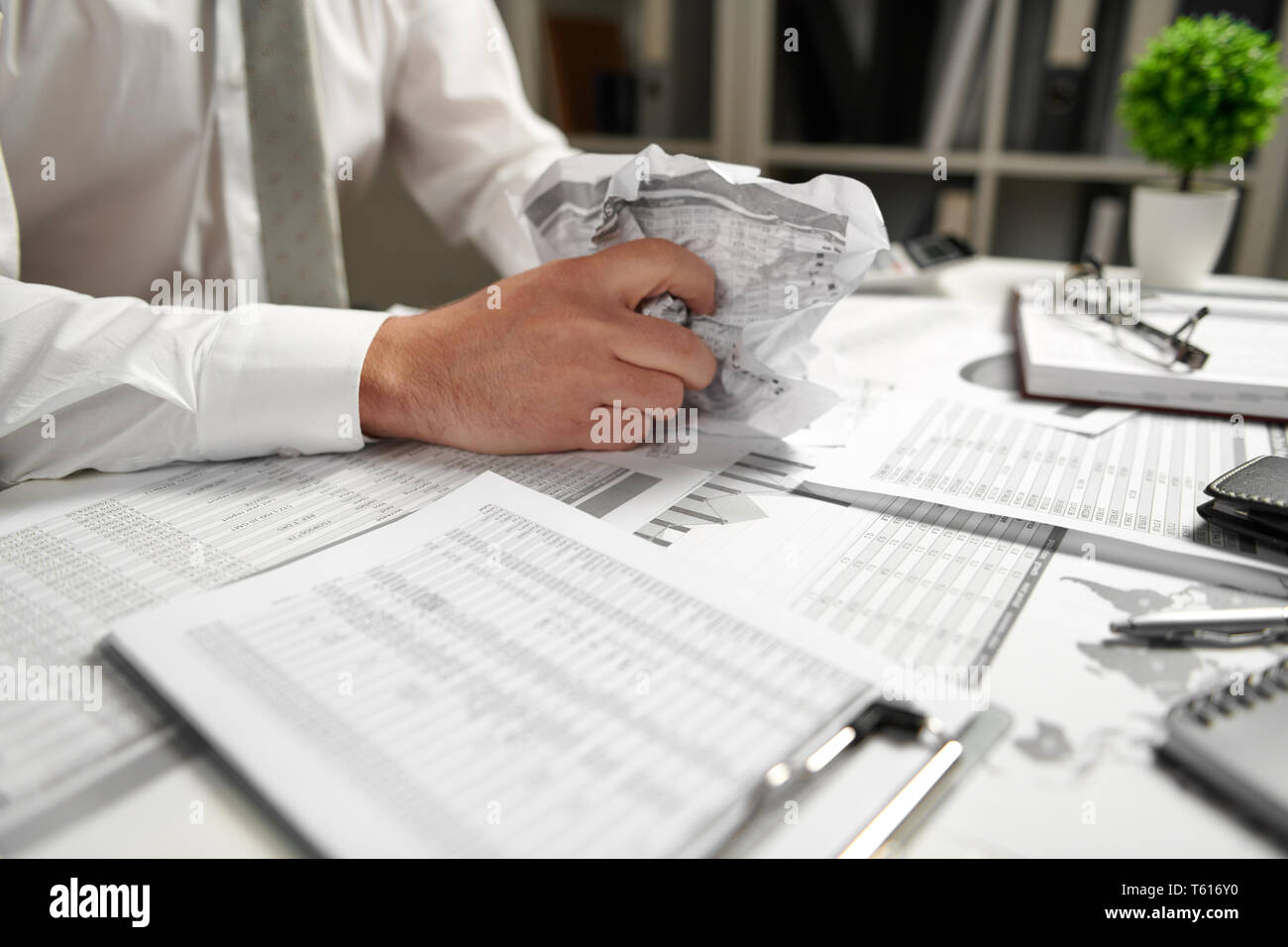 Angry businessman has stress and troubles with bad reports, he breaks ...