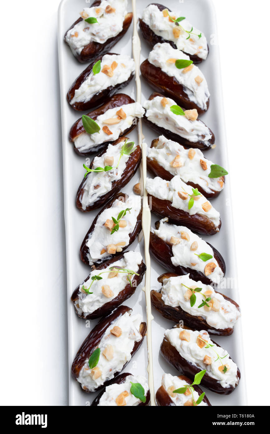 Dates stuffed with cream cheese and almonds isolated on white Stock ...