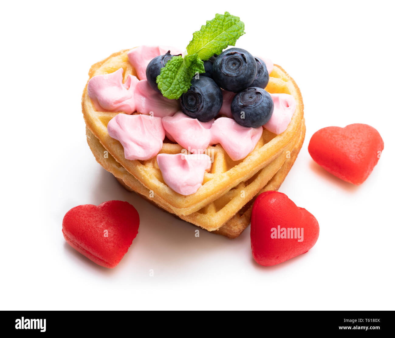 Stack of heart shaped waffles with pink cream and blueberry isolated on ...