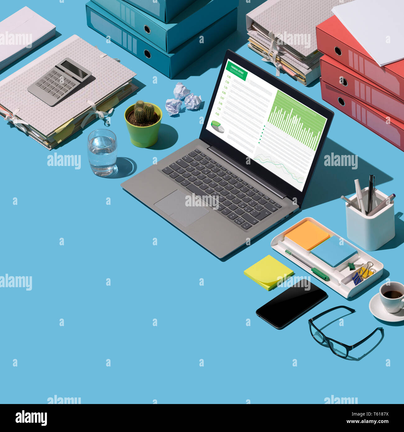 Financial report on a laptop screen, paperwork and office supplies on a ...