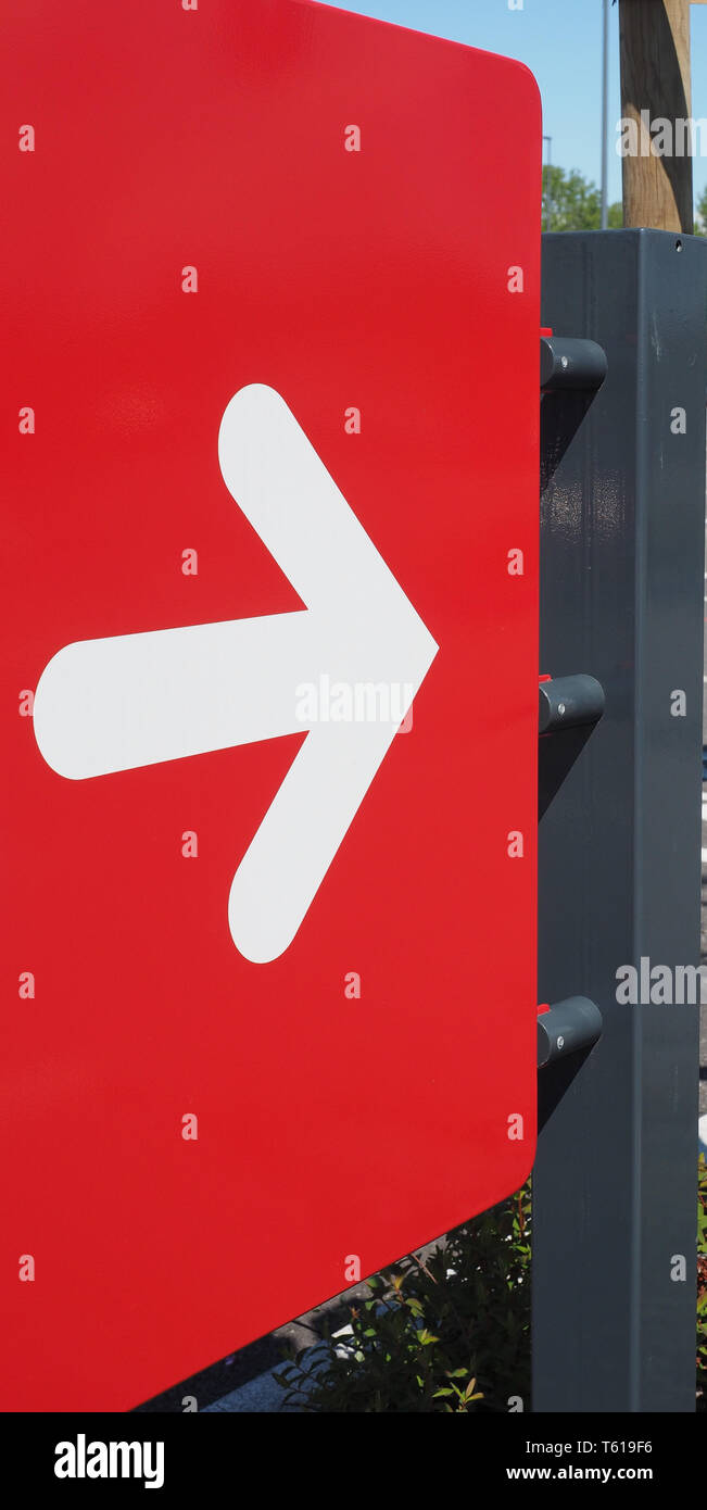 right direction arrow sign in white over red background Stock Photo - Alamy