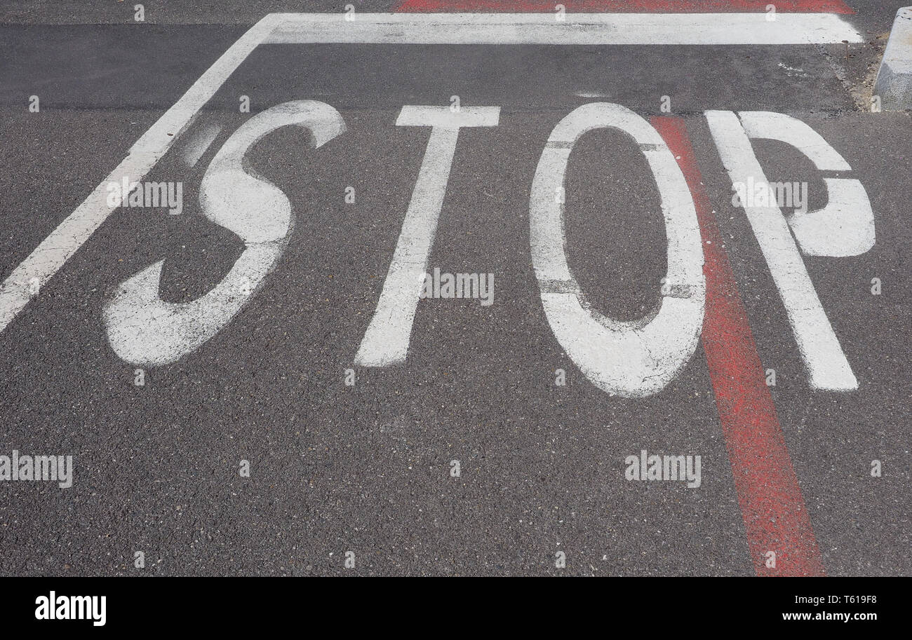 Regulatory signs, stop traffic sign painted on road Stock Photo - Alamy