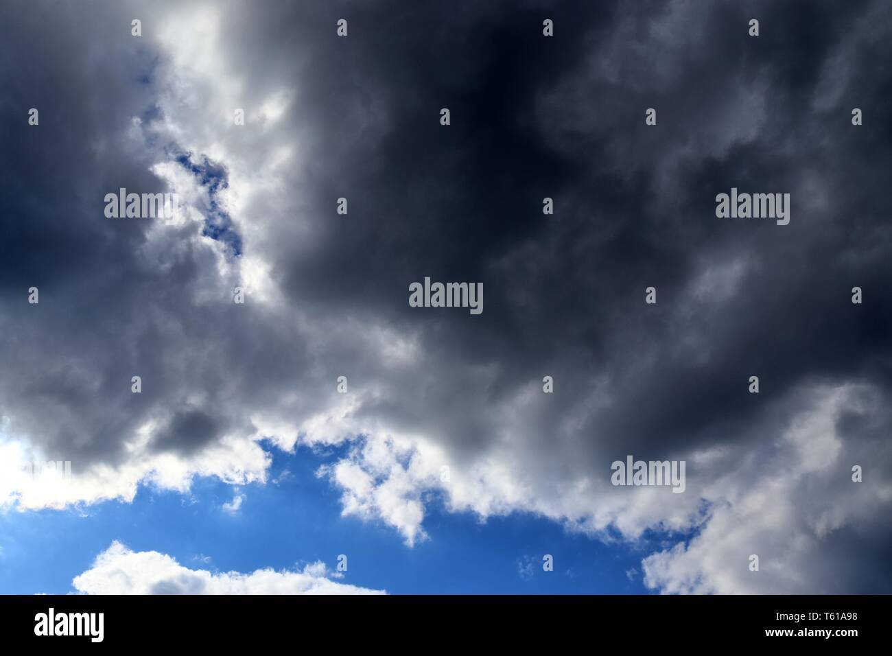 Dark forming clouds with blue sky elements right before a thunderstorm ...