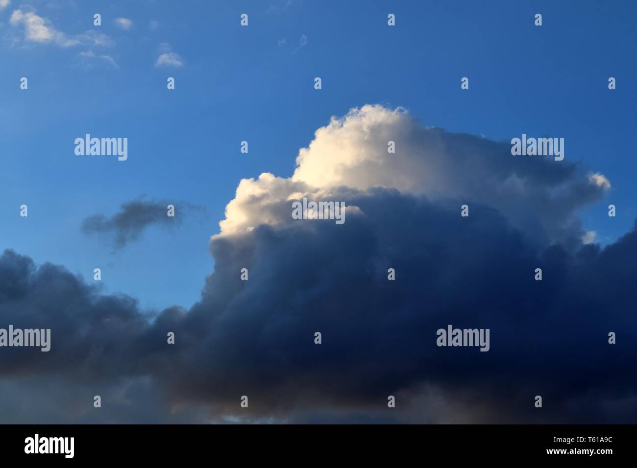 Dark forming clouds with blue sky elements right before a thunderstorm ...