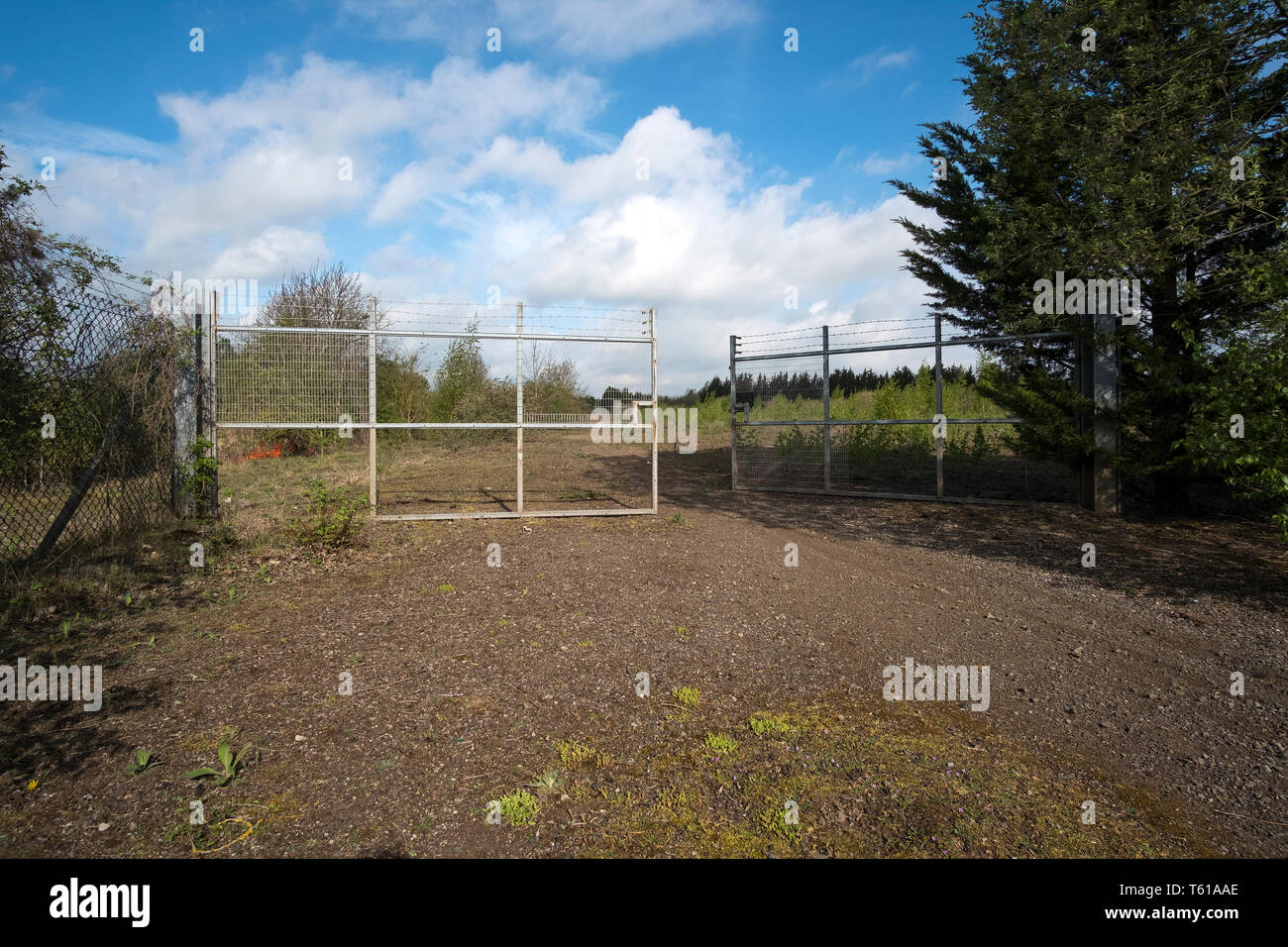 Open disused security gate Stock Photo - Alamy