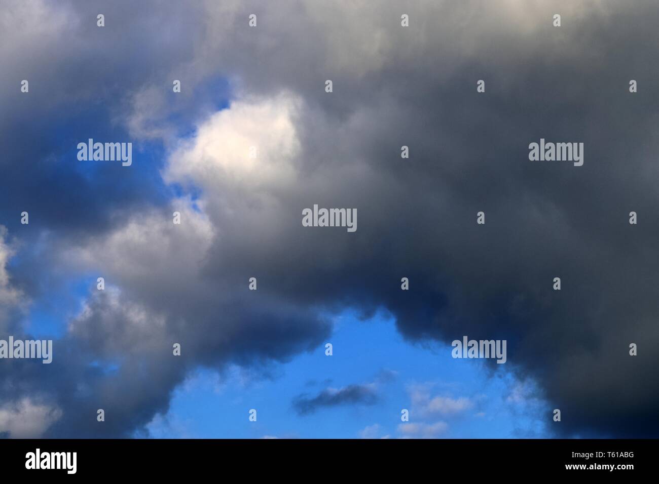 Dark forming clouds with blue sky elements right before a thunderstorm ...