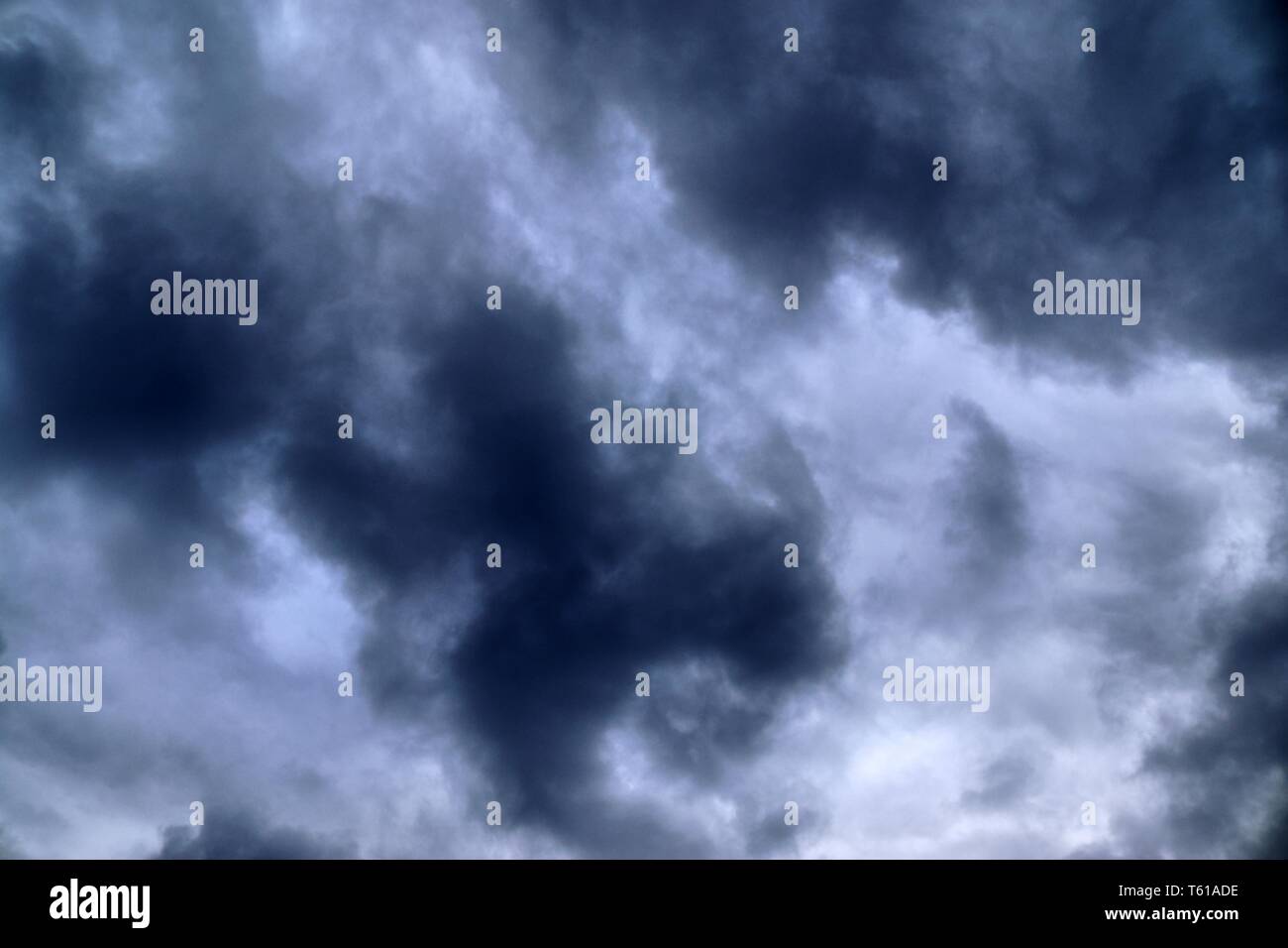 Dark forming clouds with blue sky elements right before a thunderstorm ...