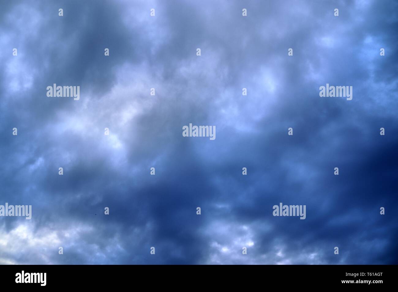 Dark forming clouds with blue sky elements right before a thunderstorm ...