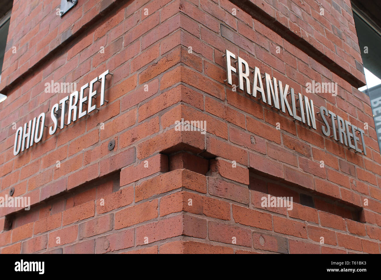 Street signs at the ohio and franklin intersection on a building with ...