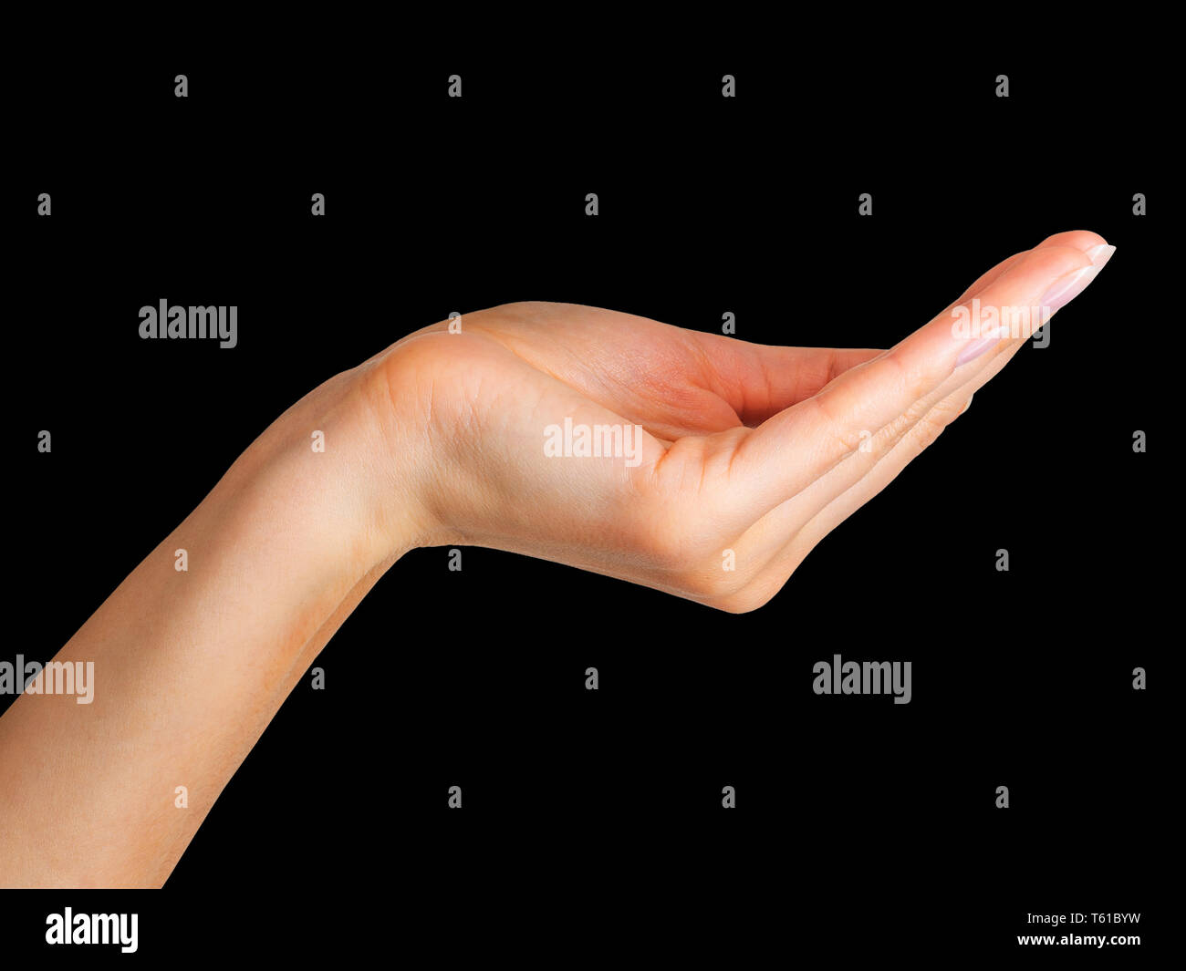 Woman showing open hand or holding something on black background ...