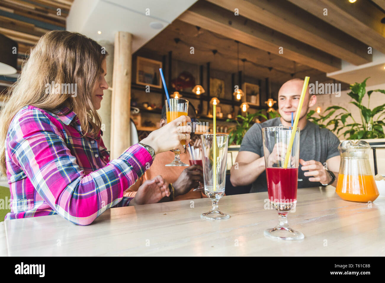 A company of young people having fun, drinking drinks, cocktails ...