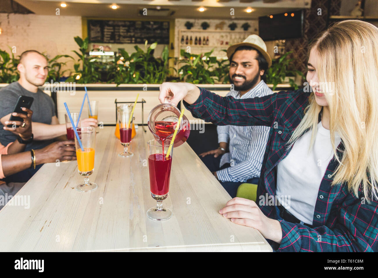 A company of young people having fun, drinking drinks, cocktails ...