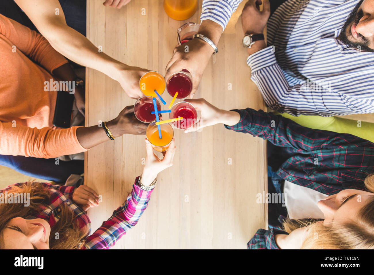 A company of young people having fun, drinking drinks, cocktails ...