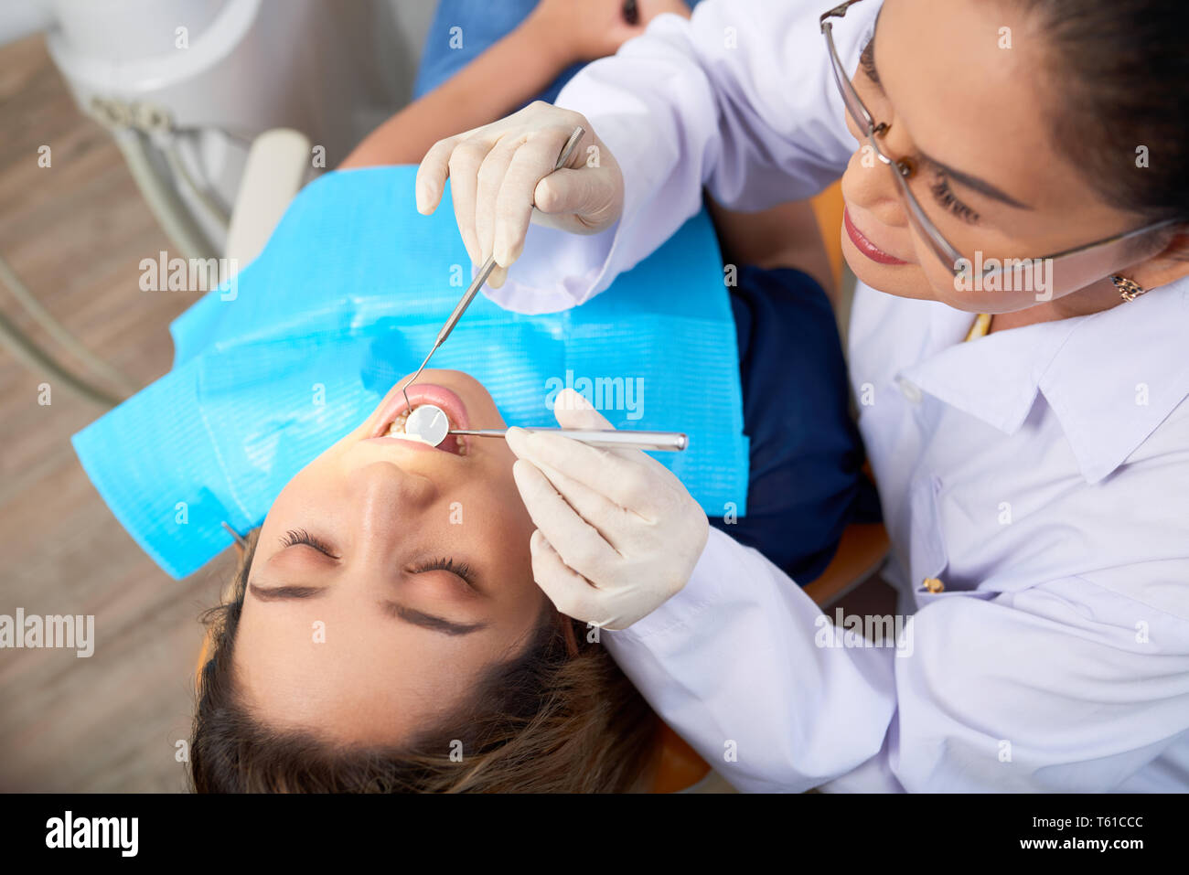 Doctor examining teeth of patient Stock Photo - Alamy