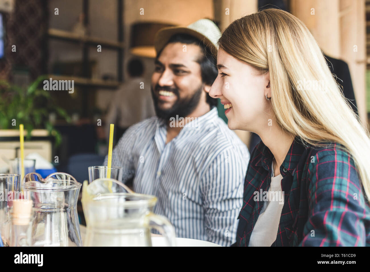 Meet young attractive people in the cafe. Friends chat, have fun, drink ...
