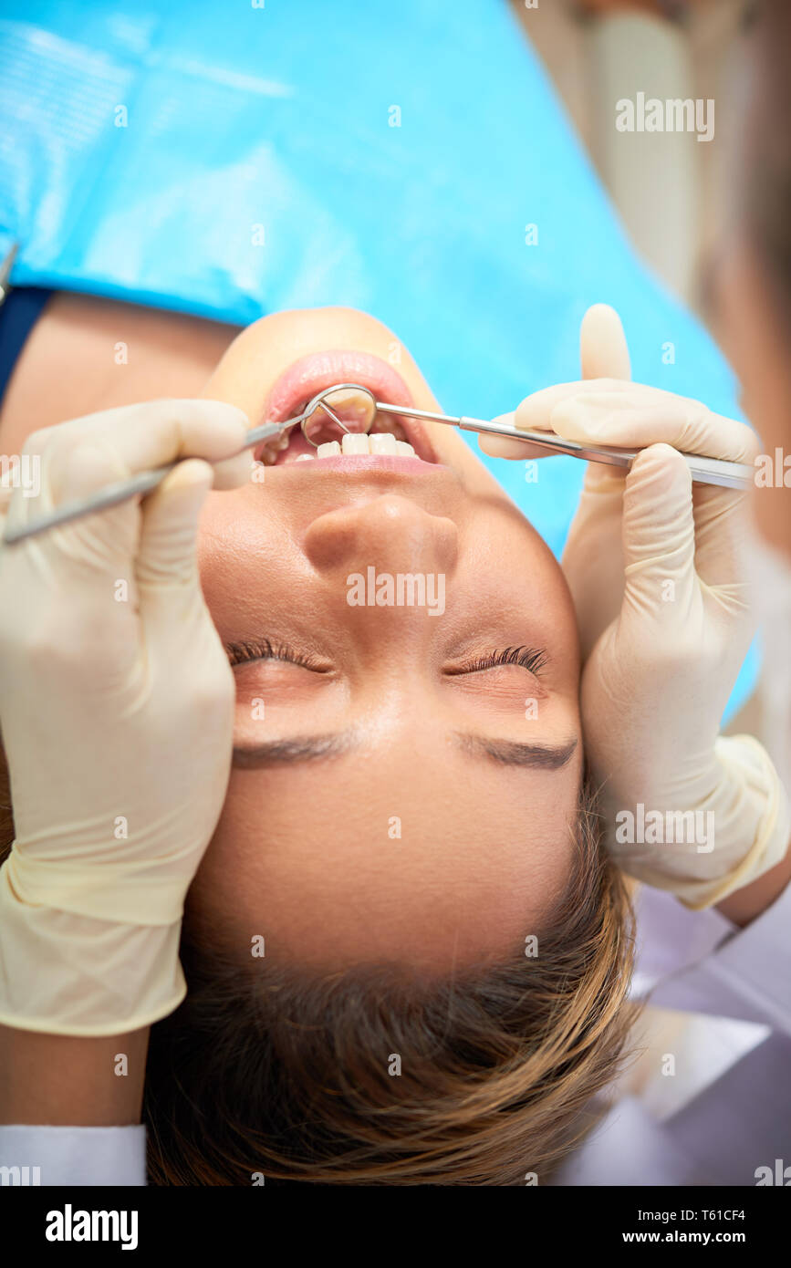 Doctor checking teeth of patient Stock Photo - Alamy
