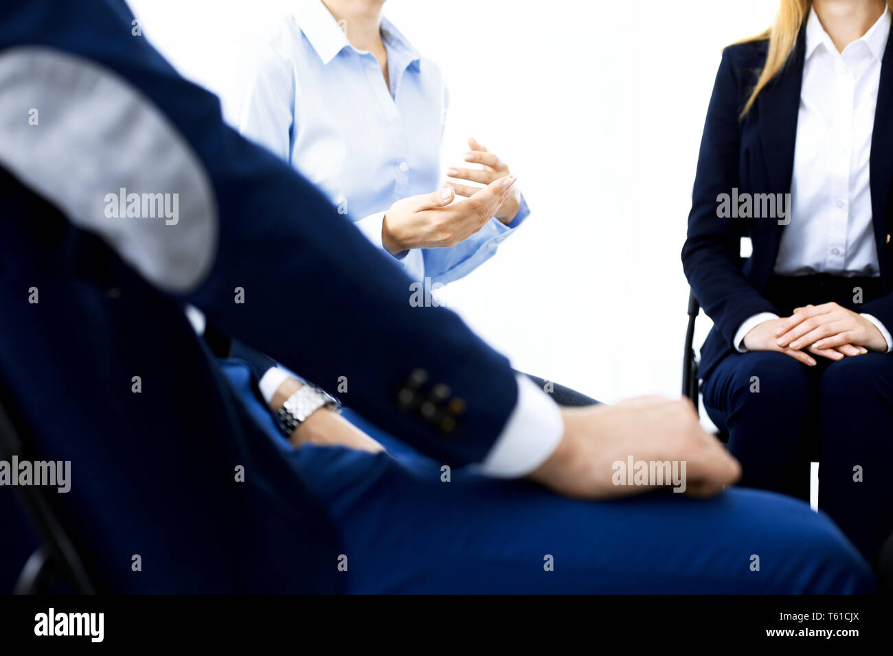 Group of people sitting in a circle during therapy. Meeting of business ...