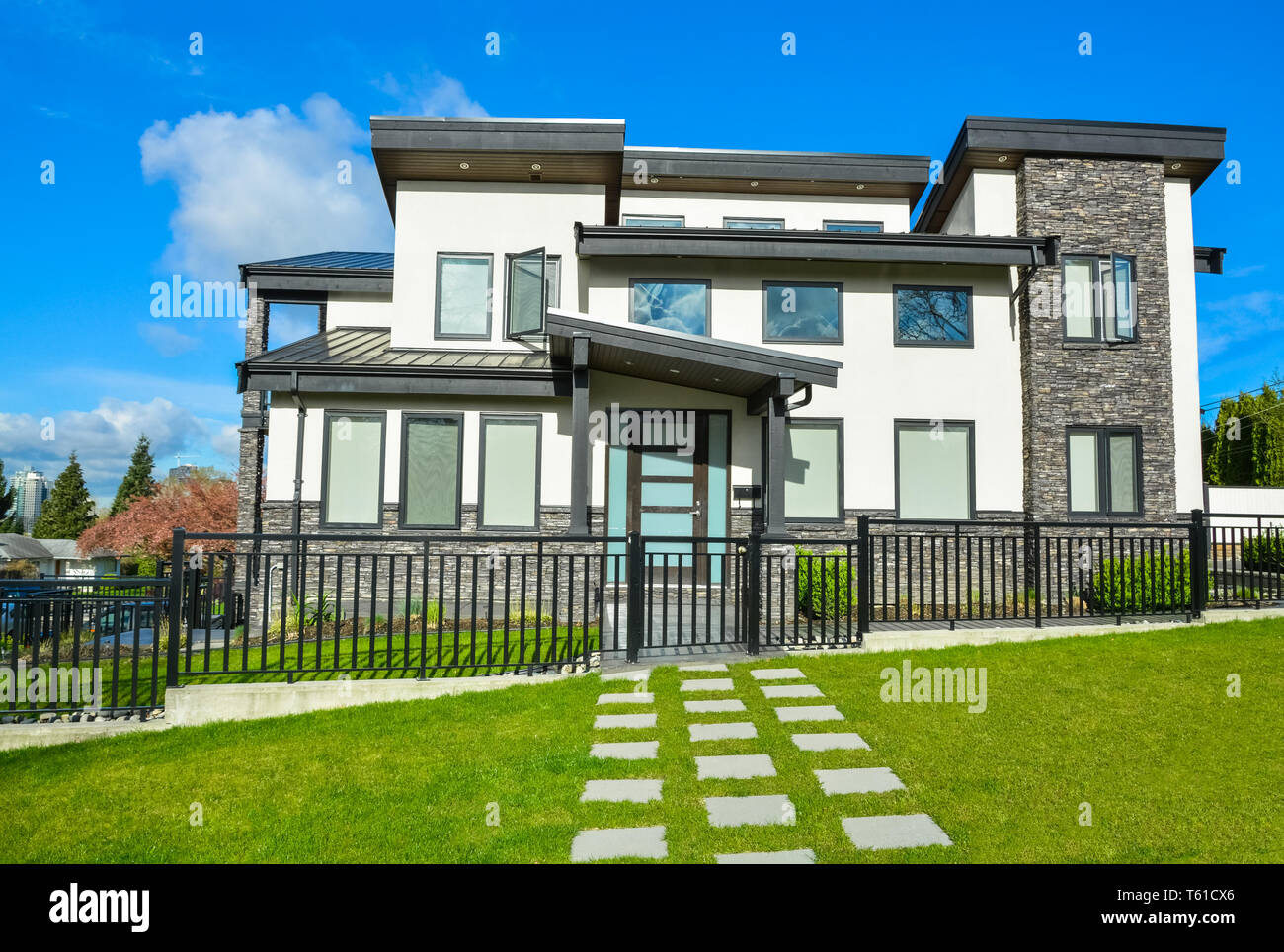 New residential house with concrete tile pathway and metal fence Stock ...