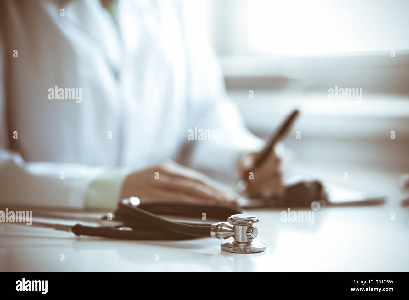 Stethoscope at doctor workplace desk. Physician woman working with ...