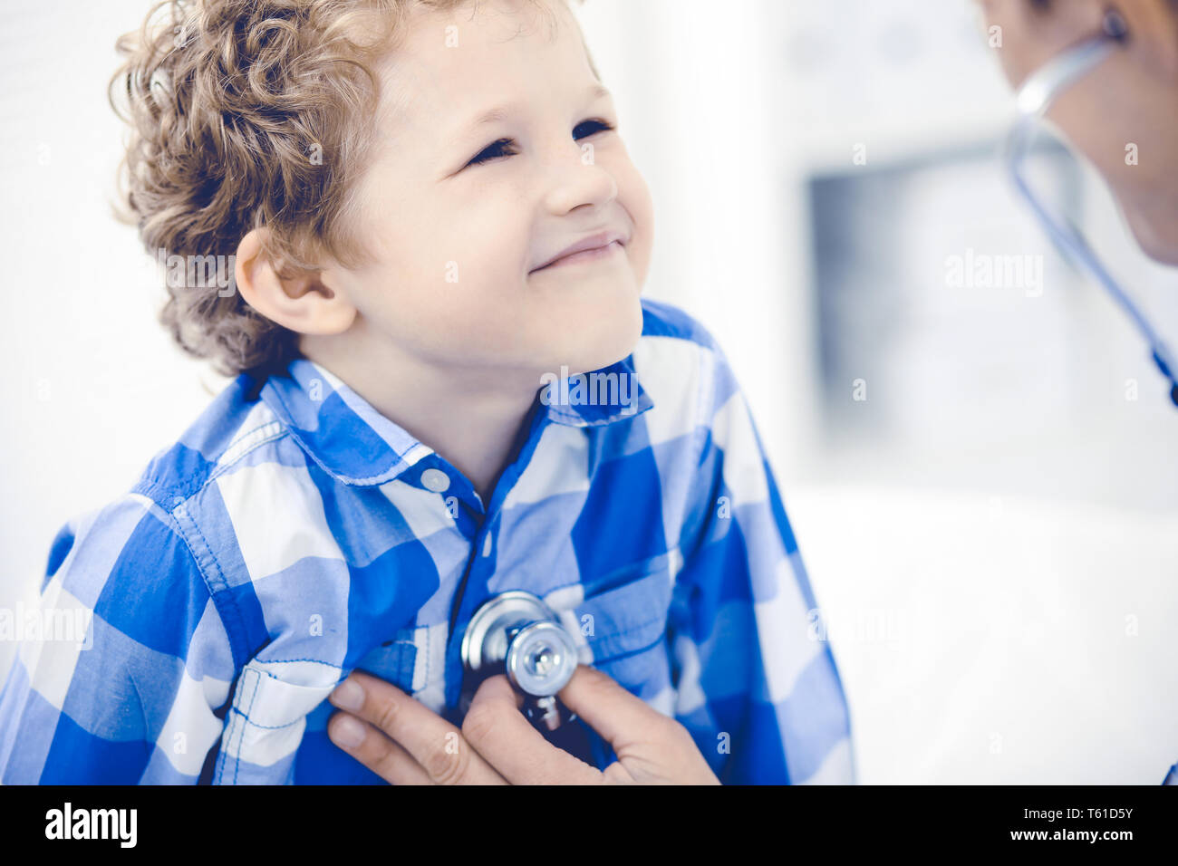 Doctor and patient child. Physician examining little boy. Regular ...