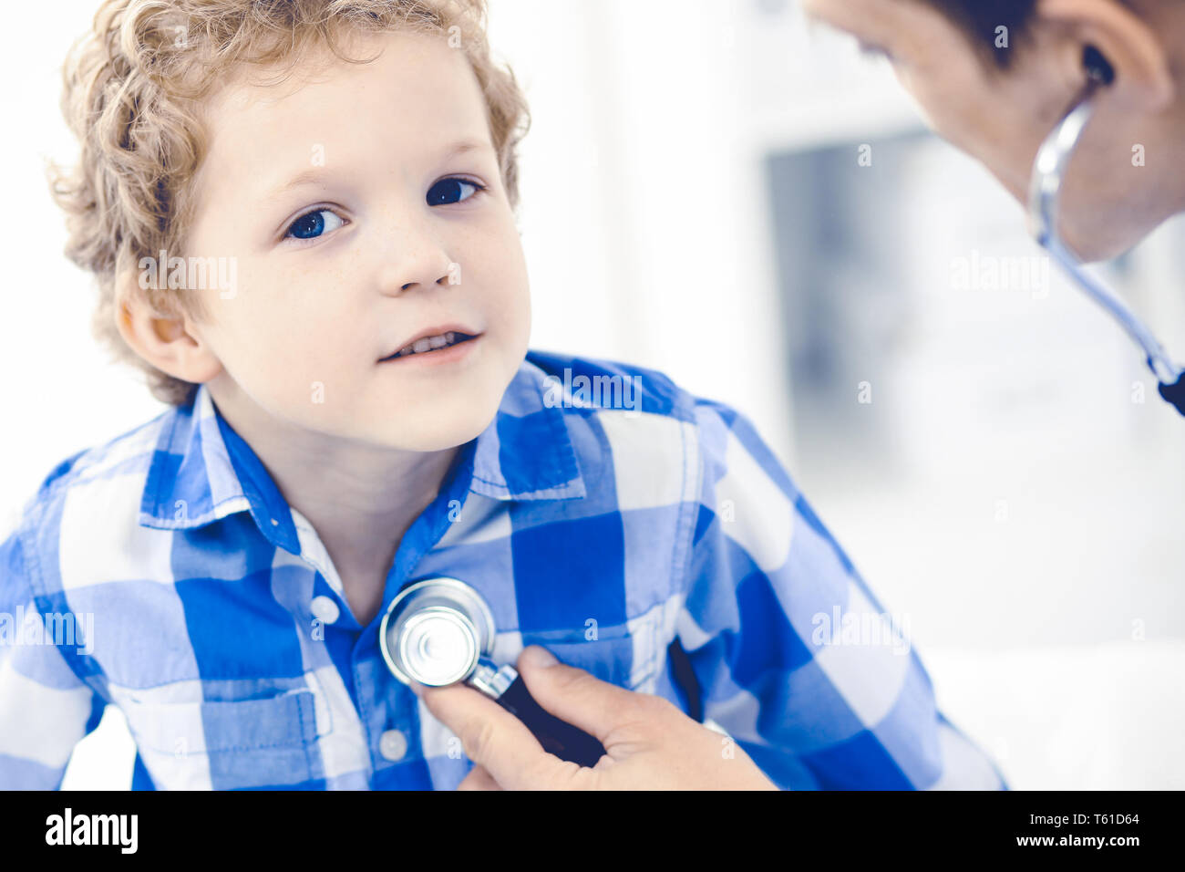 Doctor and patient child. Physician examining little boy. Regular ...