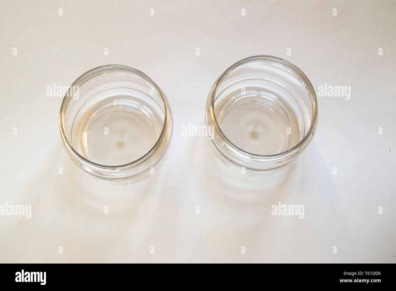 Top view of two open empty glass containers on white background Stock ...